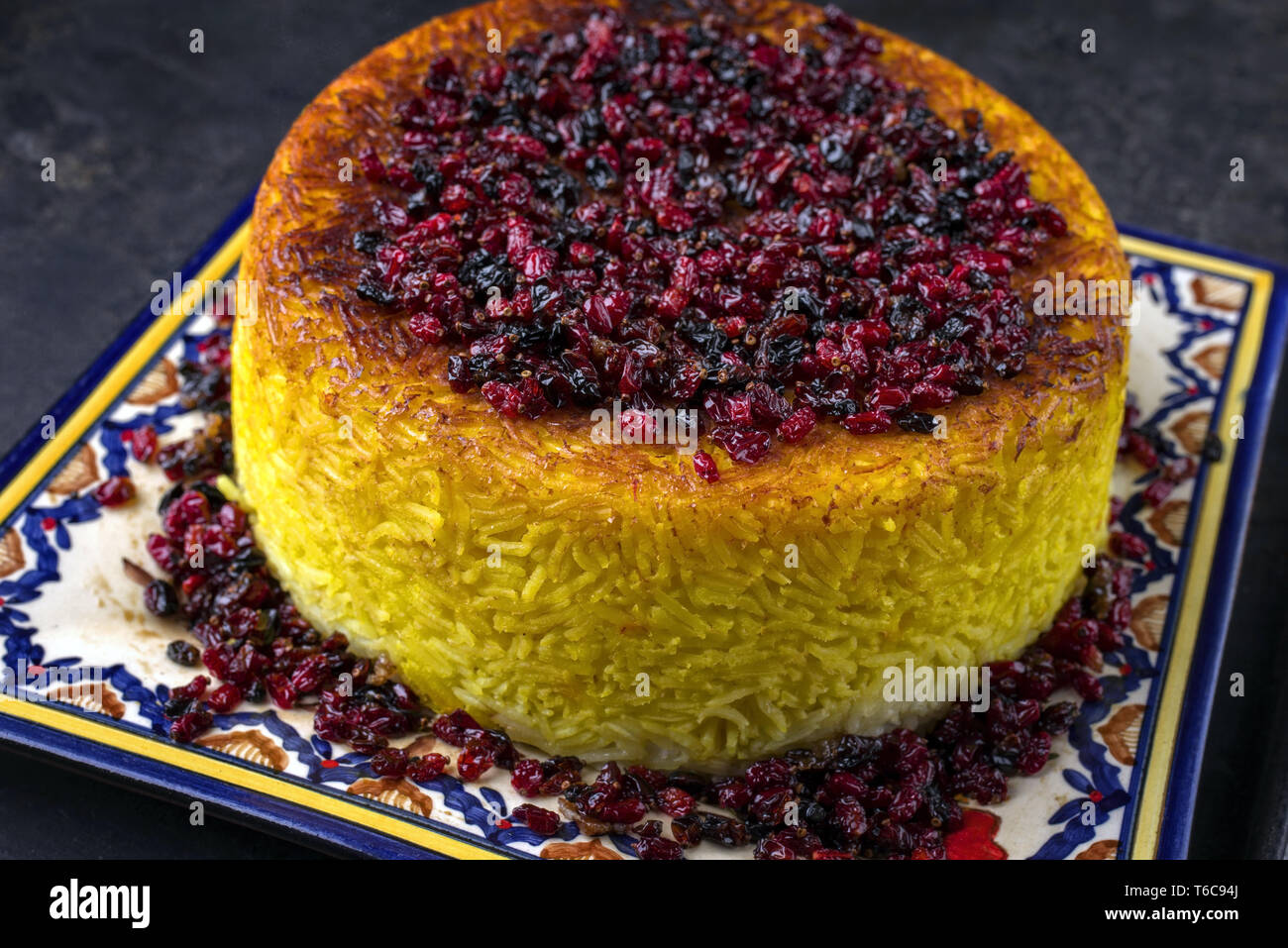 Traditional Iranian Rice pie Tahdig Polo with Berberis on a plate Stock ...