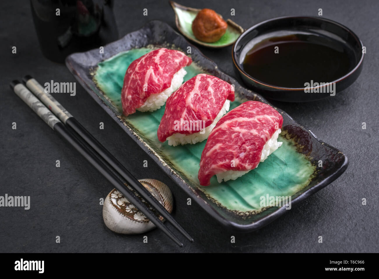 Traditional Japanese Wagyu Nigiri Sushi with Umiboshi as close-up on a ...