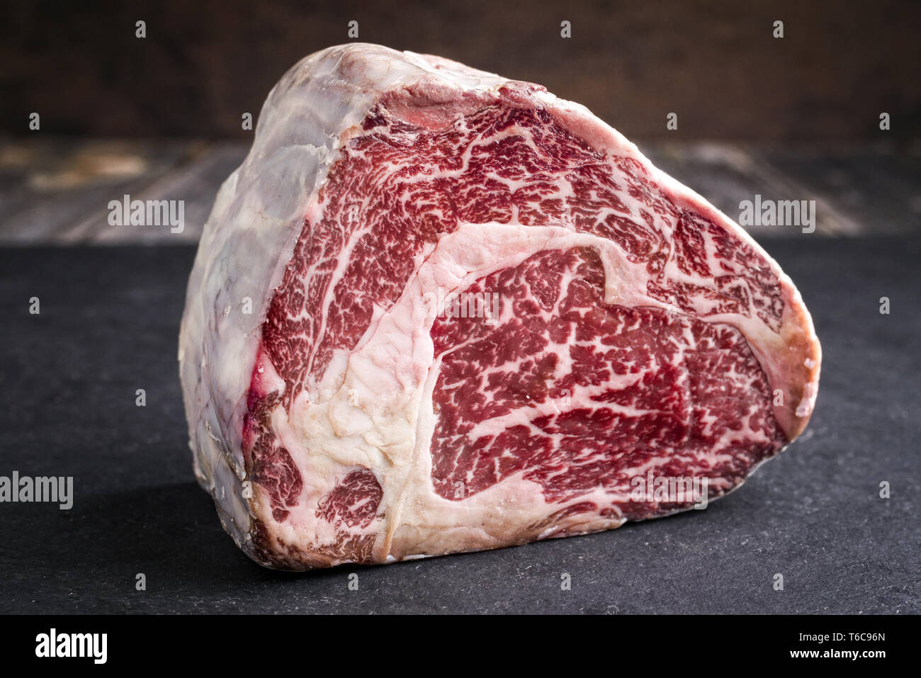 Raw dry aged Black Angus Entrecote Steak as close-up on a slate Stock ...