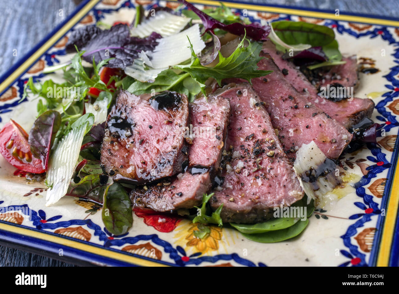 Traditional Italian Tagliata di Manzo Steak with Parmesan and Salad as ...