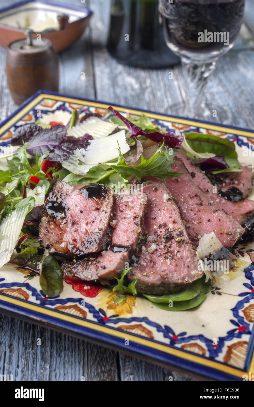 Traditional Italian Tagliata di Manzo Steak with Parmesan and Salad as ...