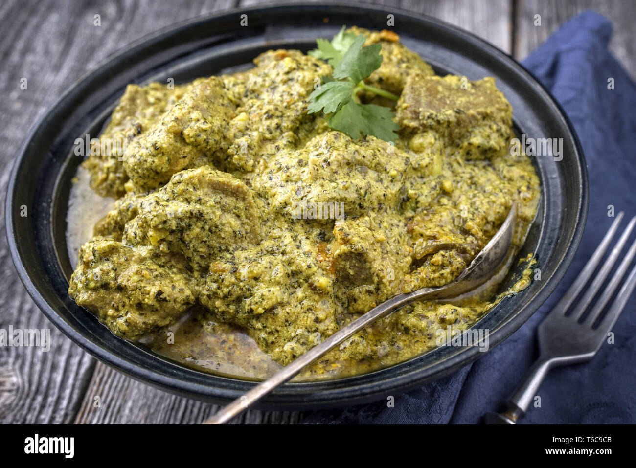 Traditional Indian Lamb Curry with Mint and Coriander as close-up in a ...