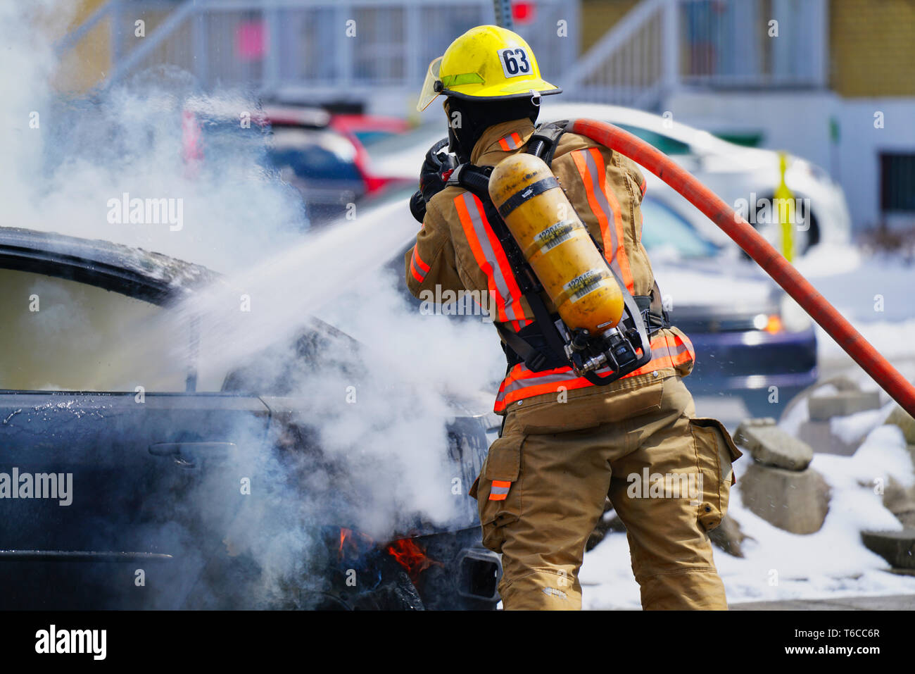 Montreal, Canada,April 10, 2019.Fireman putting out an automobile fire ...