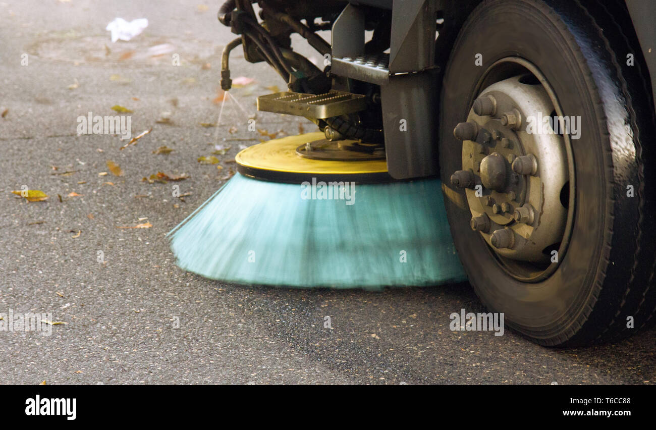 Process of cleaning street with a modern cleaning machine on streets of ...