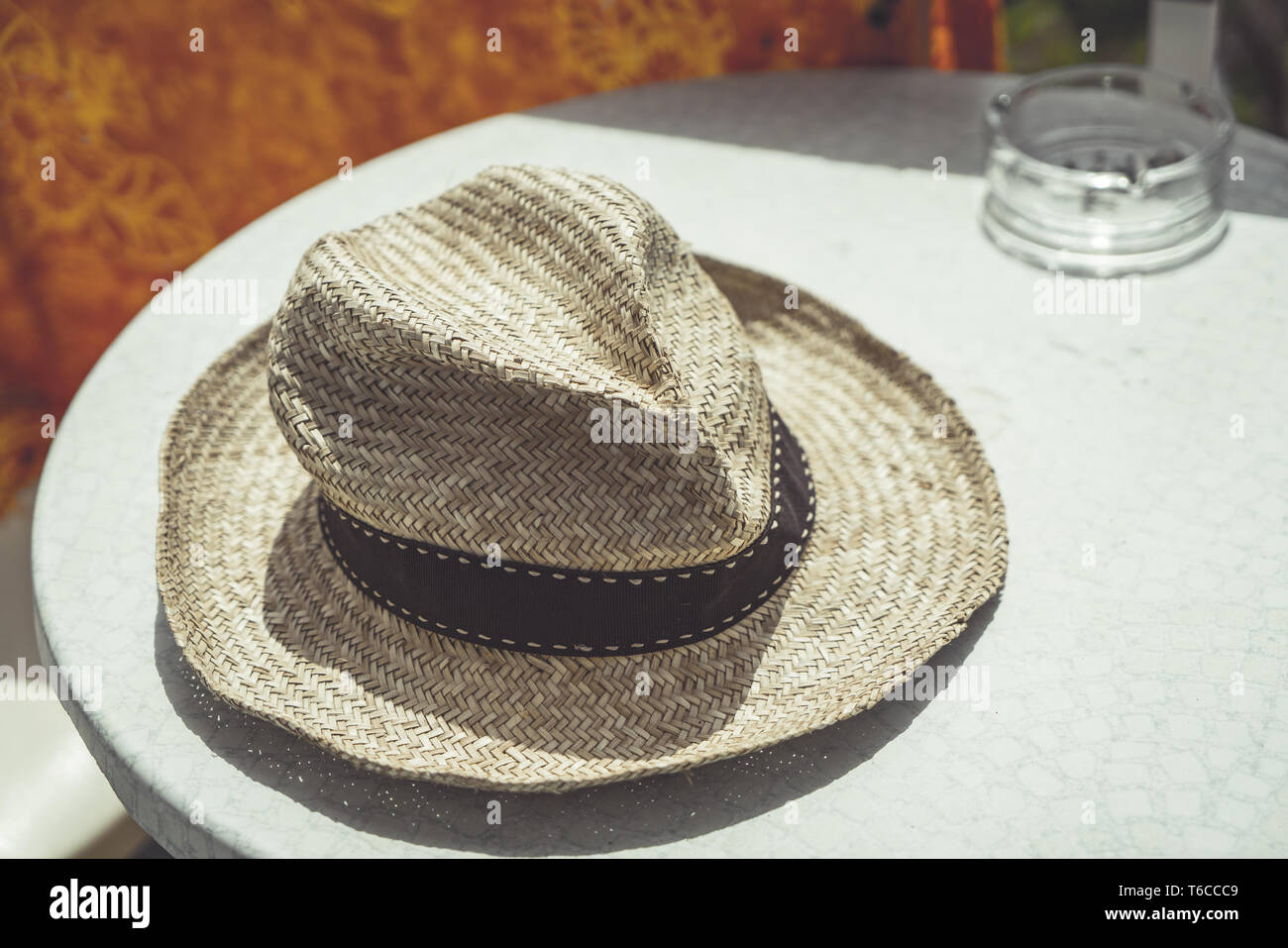 old straw hat on a table Stock Photo - Alamy