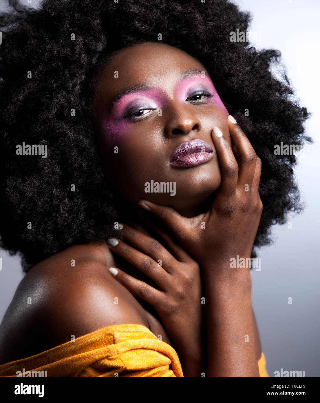 Afro and Flower beauty with big black hair smooth dark skin Stock Photo ...