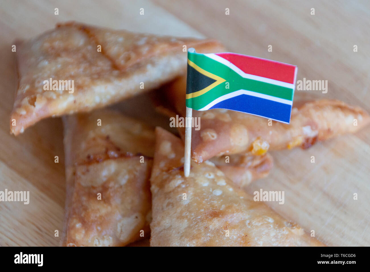 A close up view of a pile of south african samosas with a small south ...