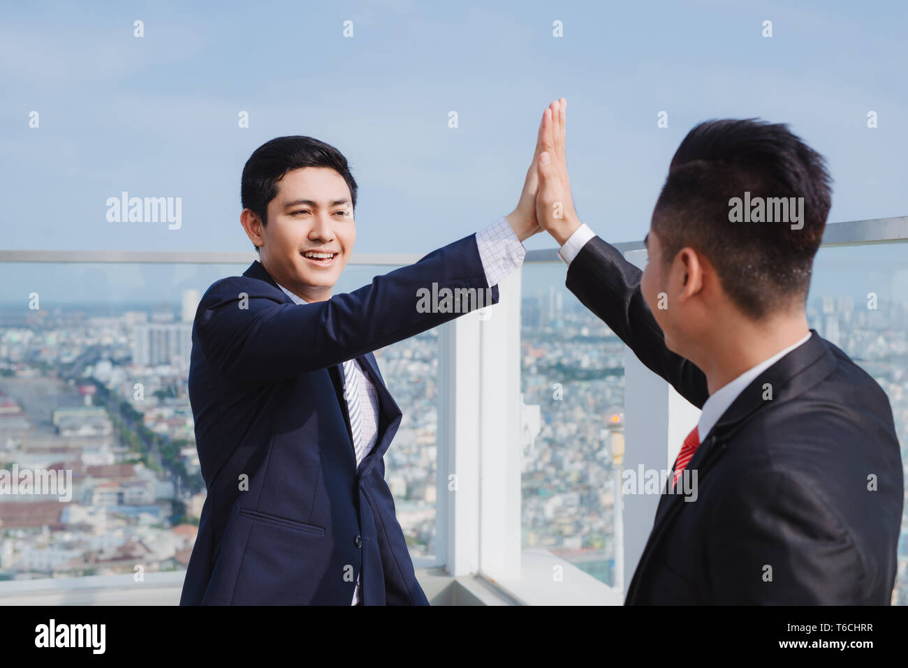 Two Happy Adult Business Men High Fiving Stock Photo - Alamy