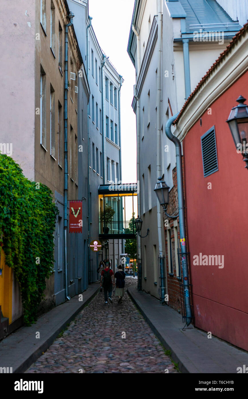 Tourists visit one of the most popular Pilies street of the old town ...