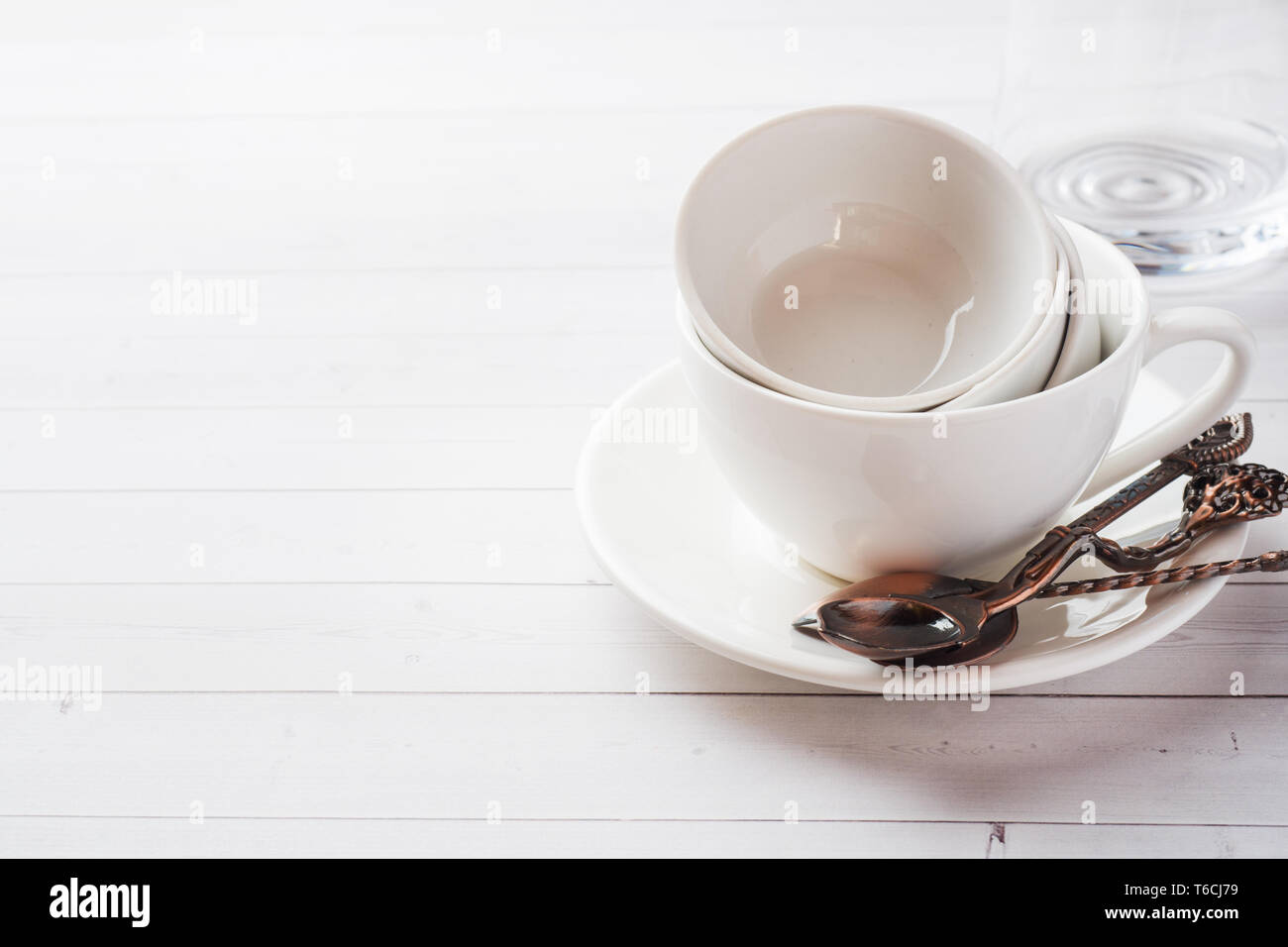 Clean dishes on table on white background Stock Photo - Alamy