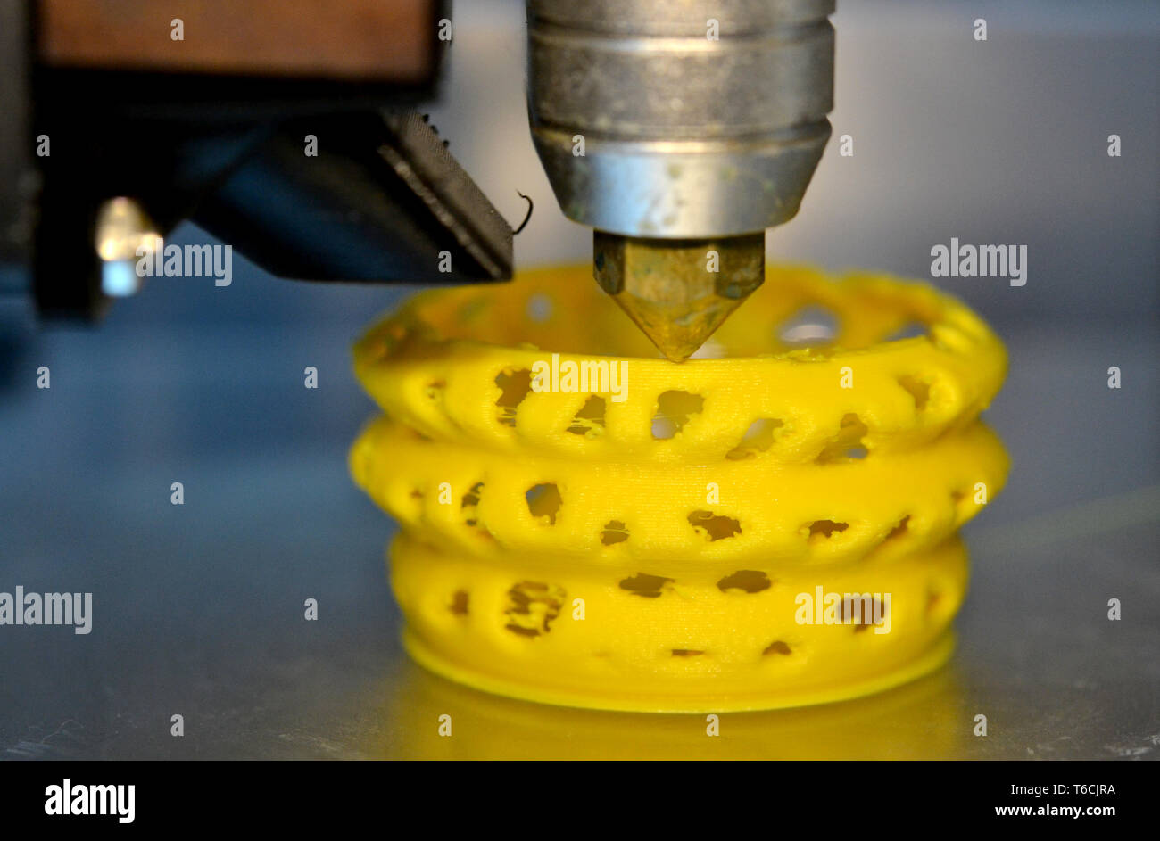 3d printer printing objects yellow form closeup. Modern technical 3D ...