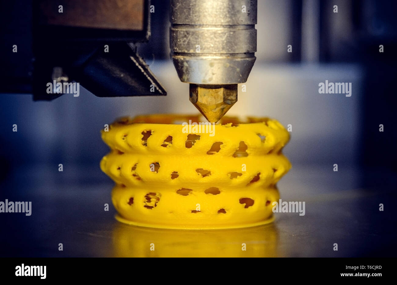 3d printer printing objects yellow form closeup. Modern technical 3D ...