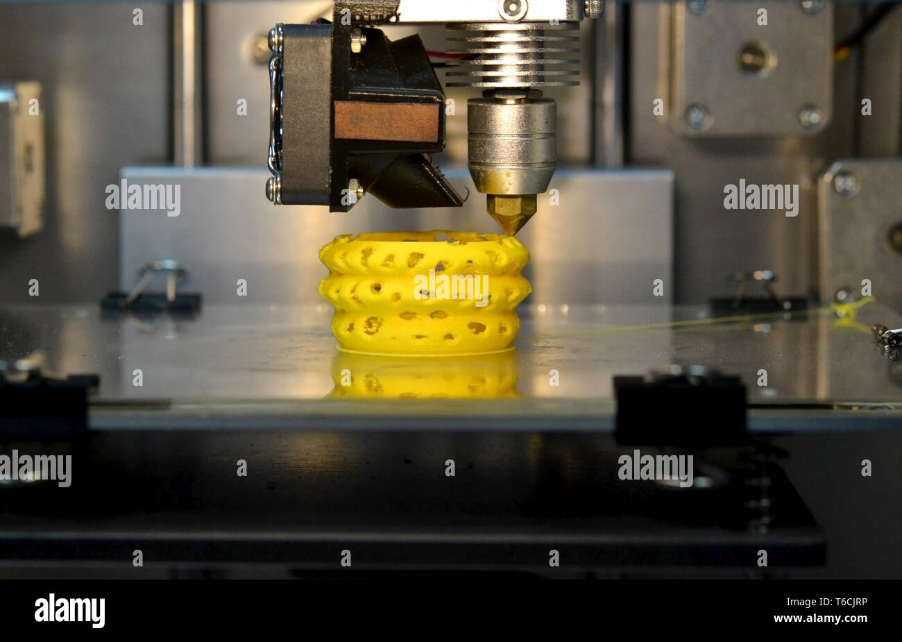 3d printer printing objects yellow form closeup. Modern technical 3D ...