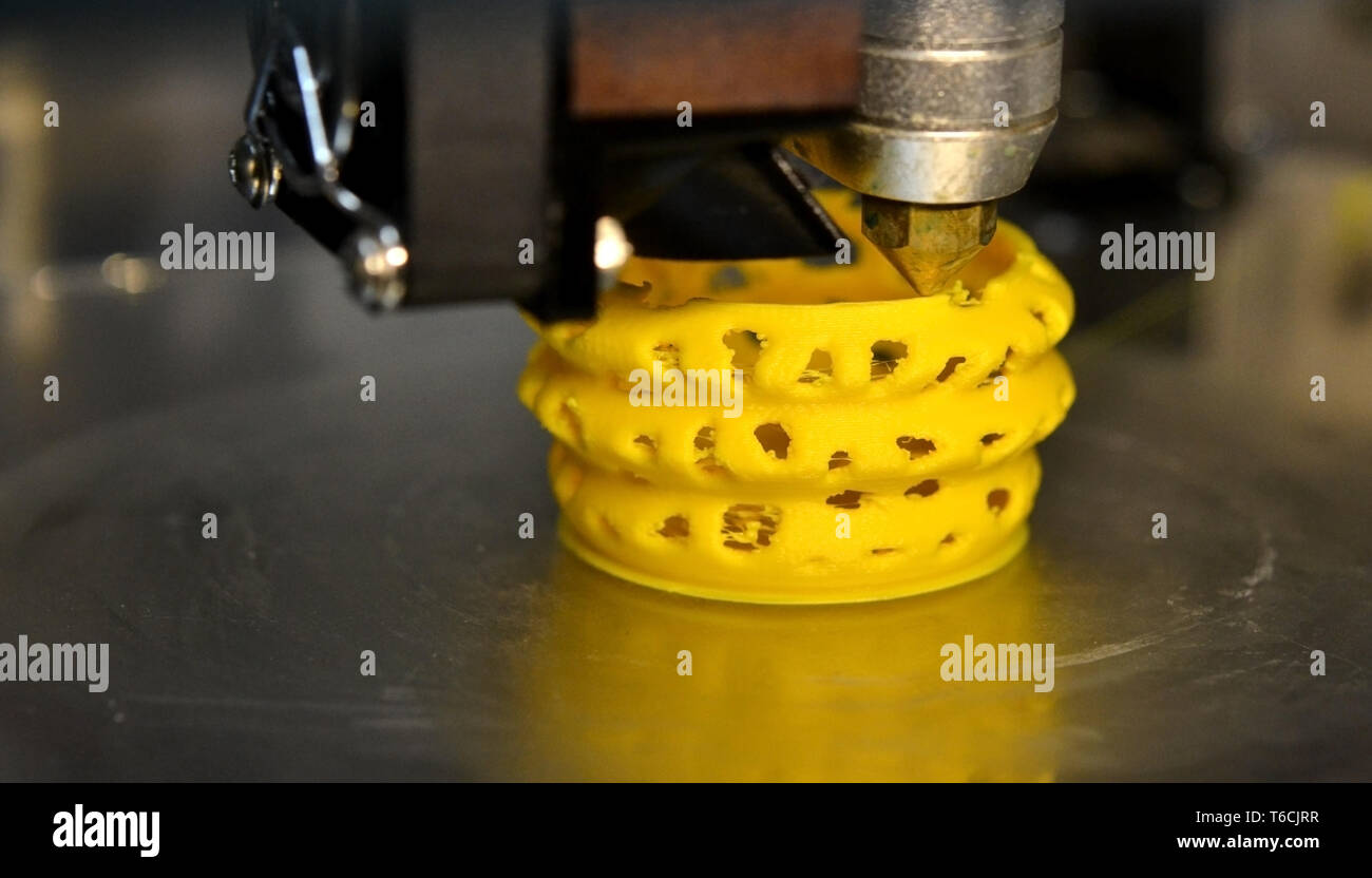 3d printer printing objects yellow form closeup. Modern technical 3D ...