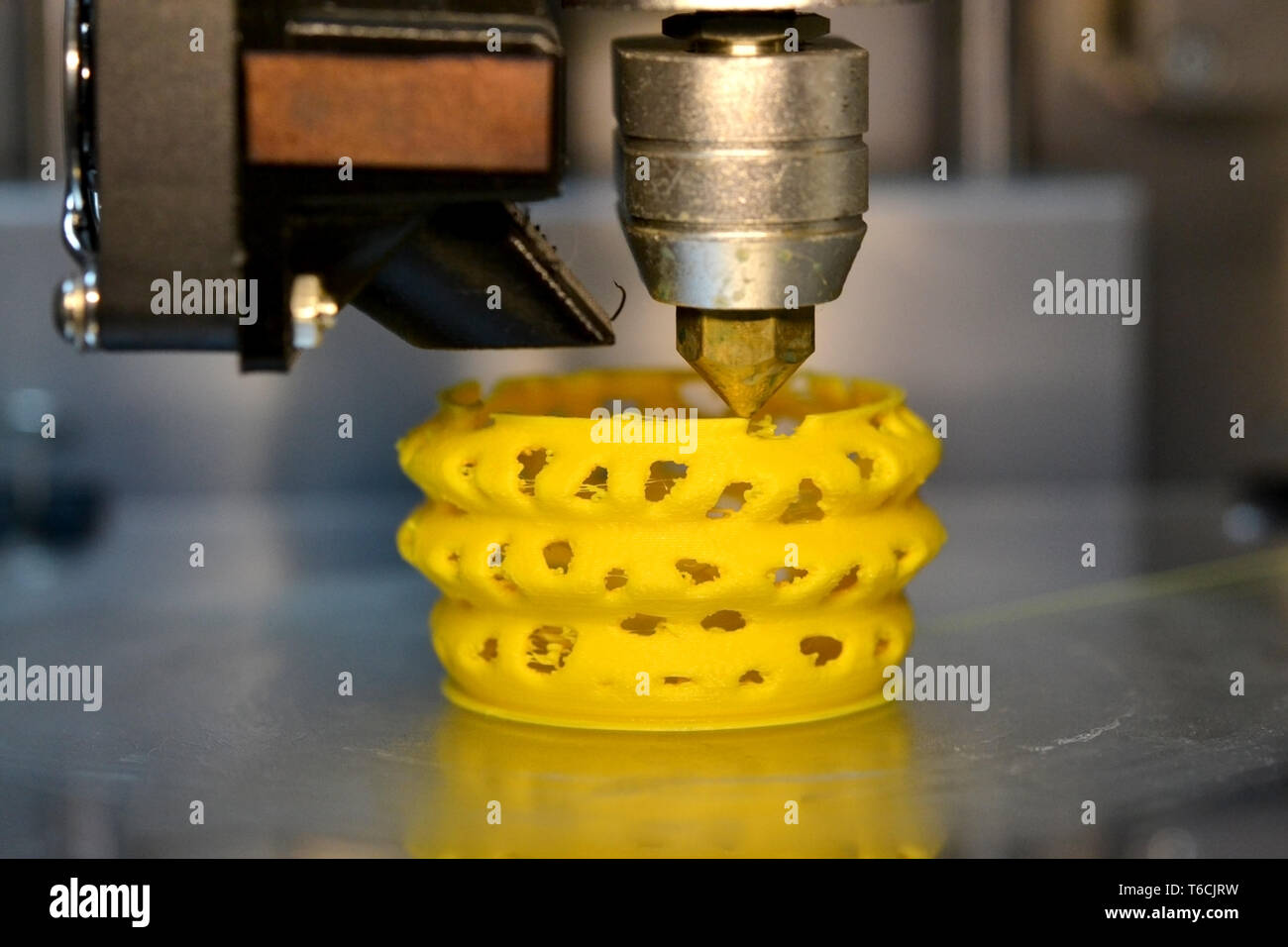 3d printer printing objects yellow form closeup. Modern technical 3D ...