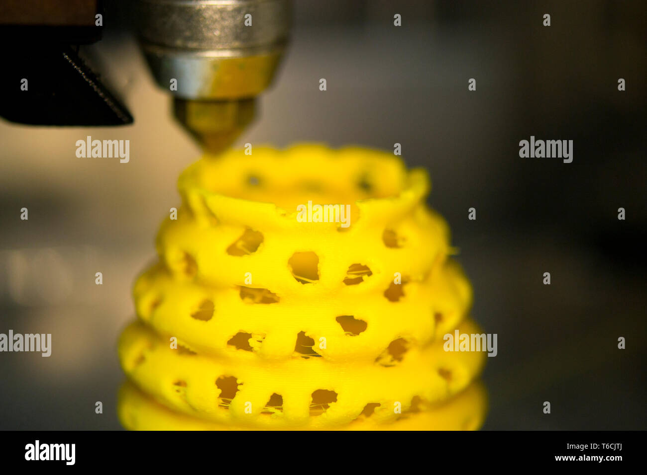 3d printer printing objects yellow form closeup. Modern technical 3D ...