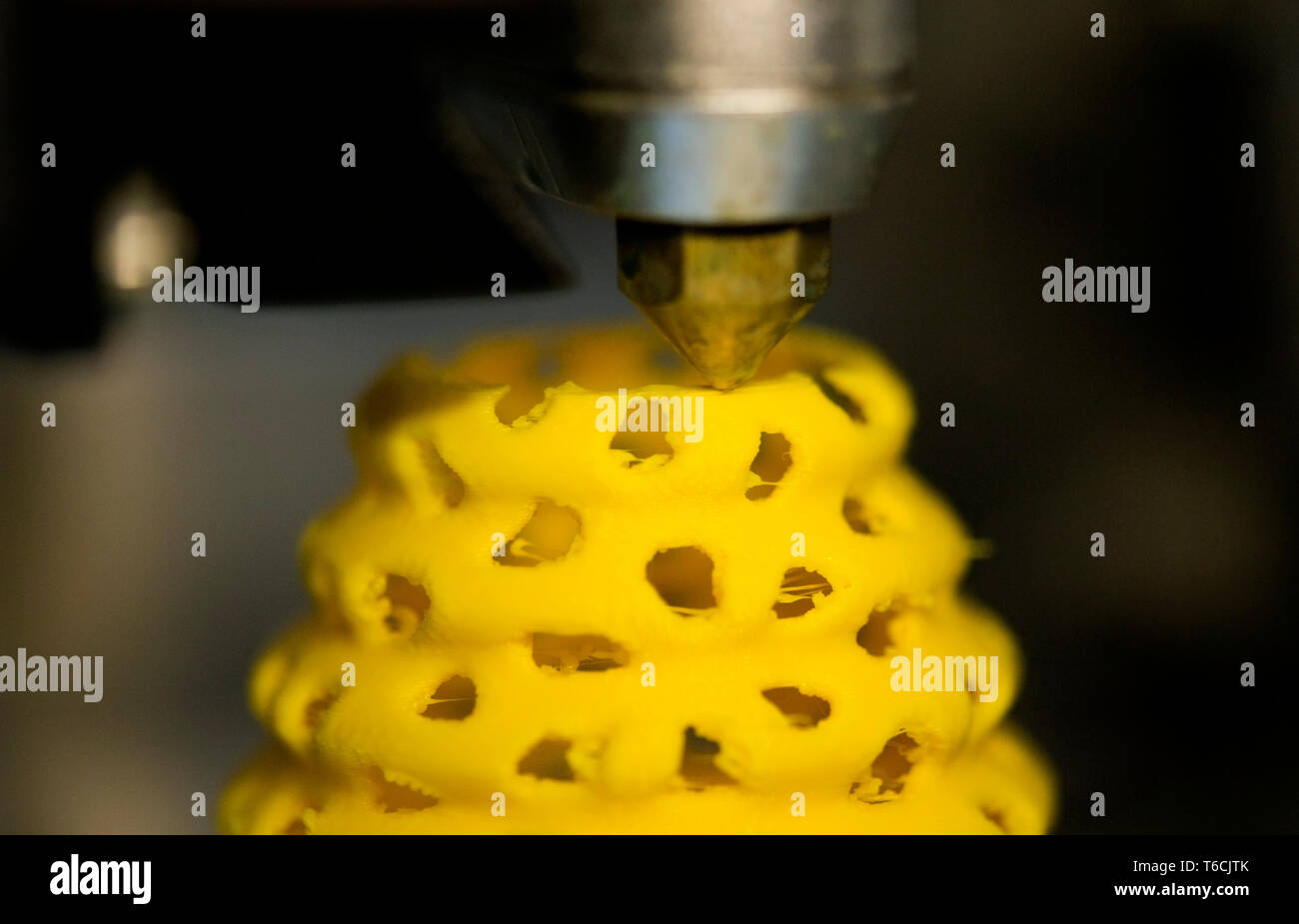 3d printer printing objects yellow form closeup. Modern technical 3D ...