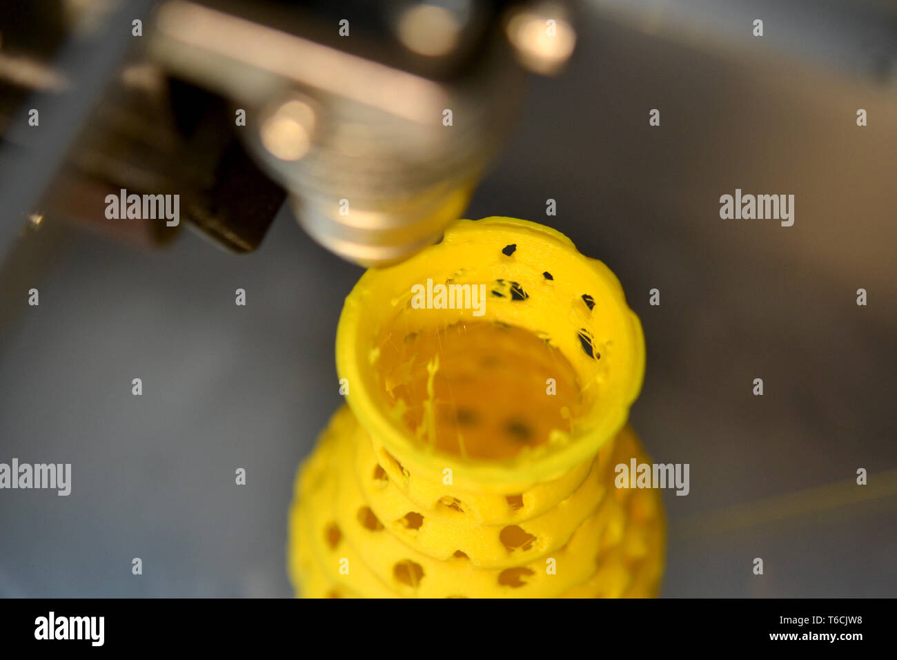 3D printer prints from the plastic figure closeup. 3D printer makes ...