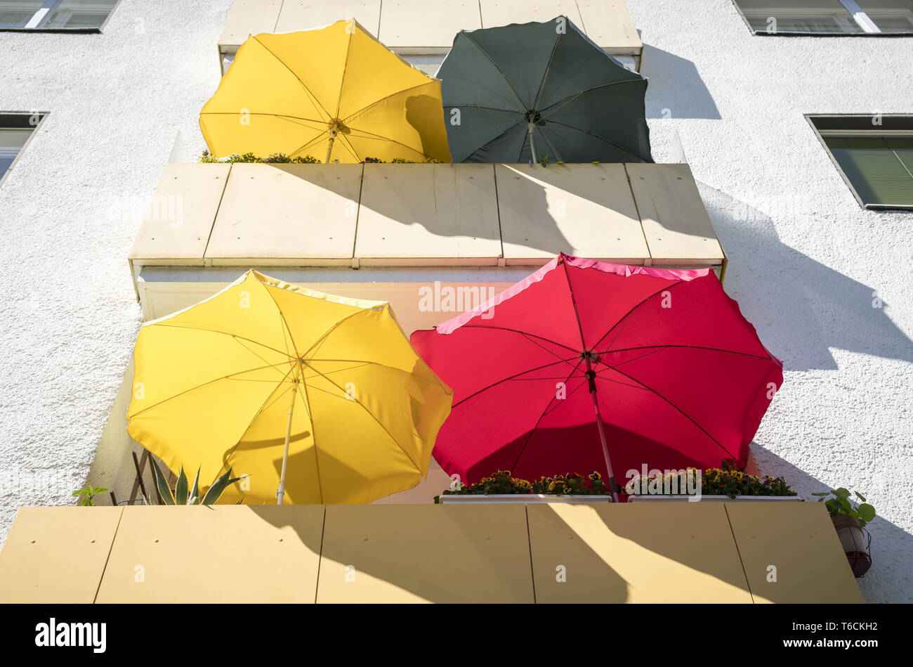 balconies in the summer with colorful parasols Stock Photo - Alamy