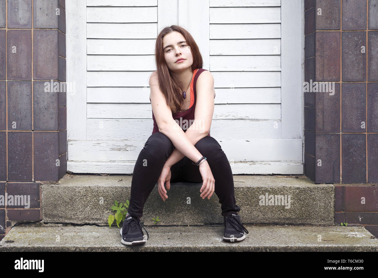 Portrait woman sitting on step hi-res stock photography and images - Alamy
