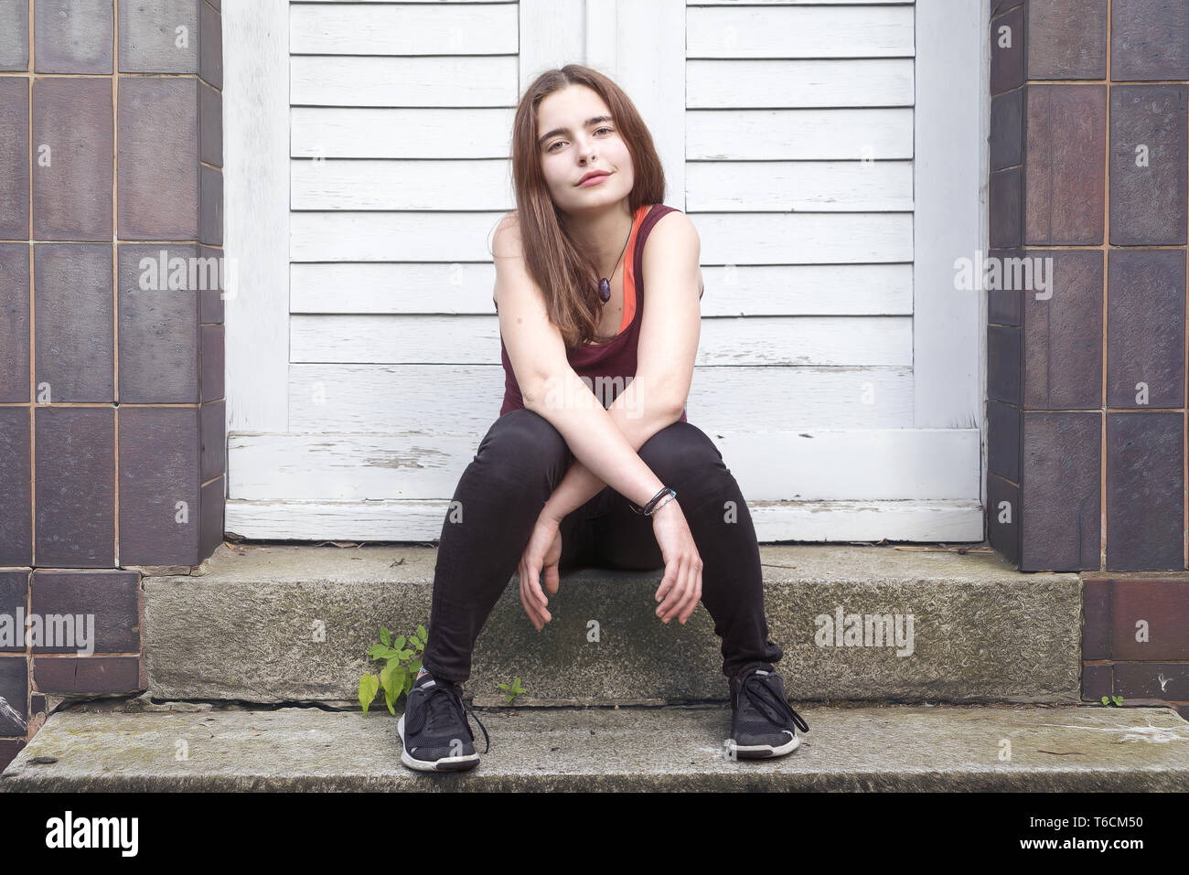 Girl sitting on step hi-res stock photography and images - Alamy