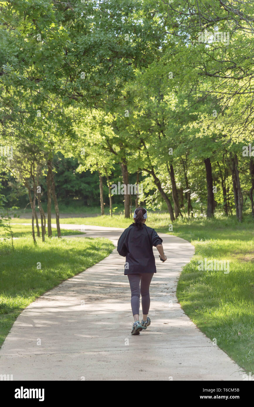 Back view of healthy Caucasian lady walking in the park in USA Stock ...