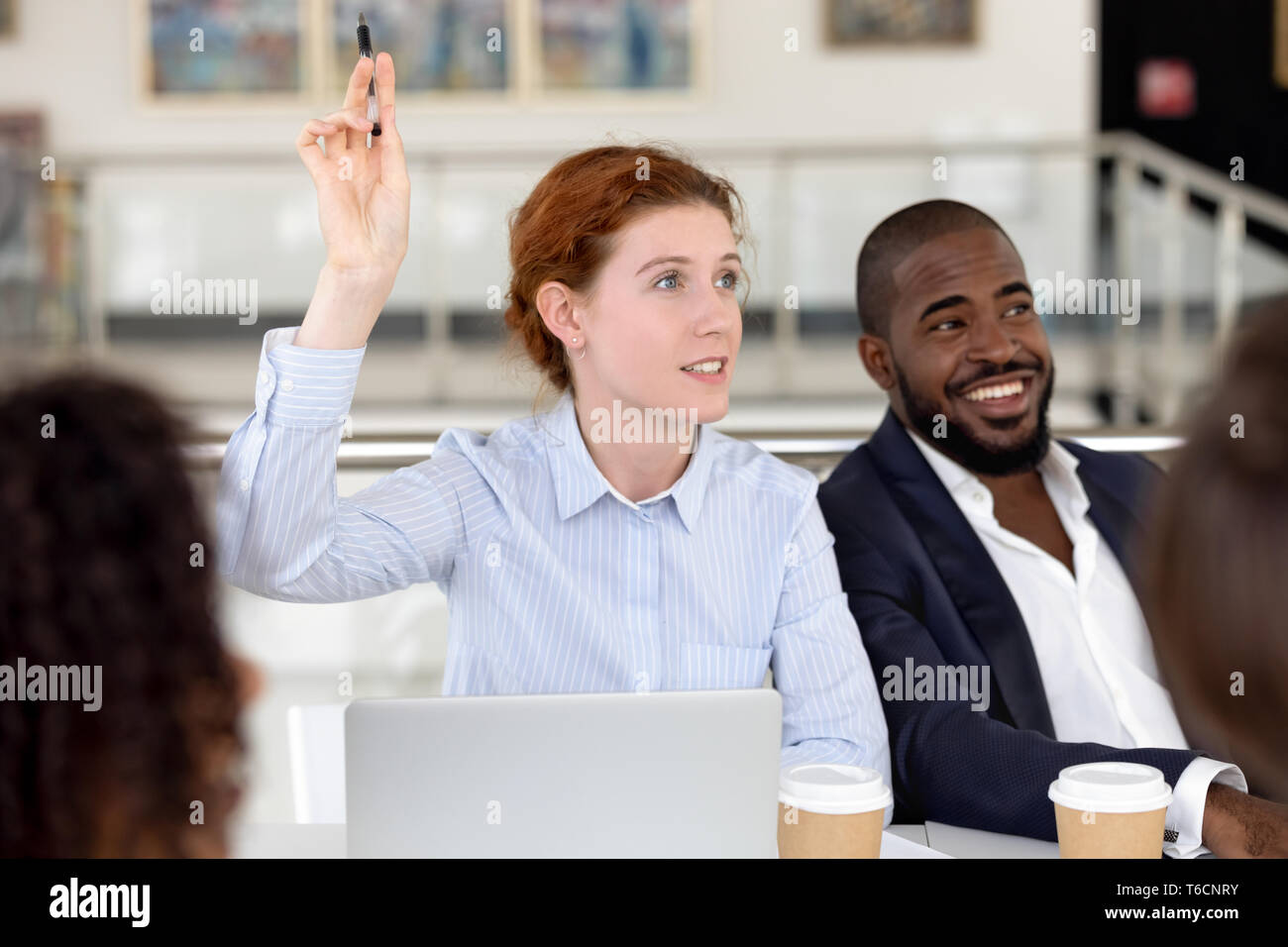 Businesswoman raising hand hi-res stock photography and images - Alamy