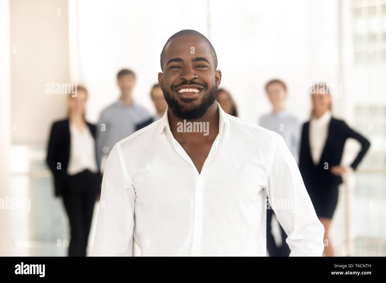 Happy african business coach corporate leader posing with diverse team ...