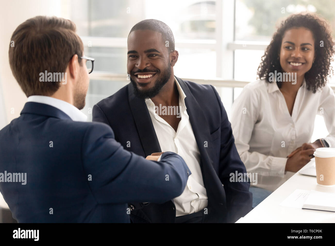 Happy african businessman handshake reliable male partner at team ...