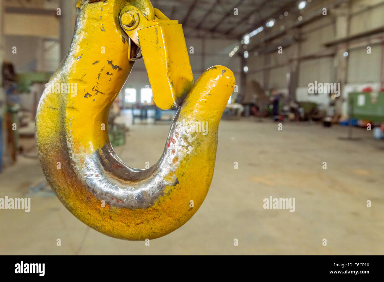 Closeup of a industrial yellow lifting crane hook in a factory Stock ...