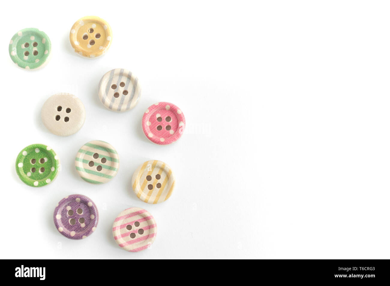 Wooden buttons with colorful stripes and colorful dots on a white ...