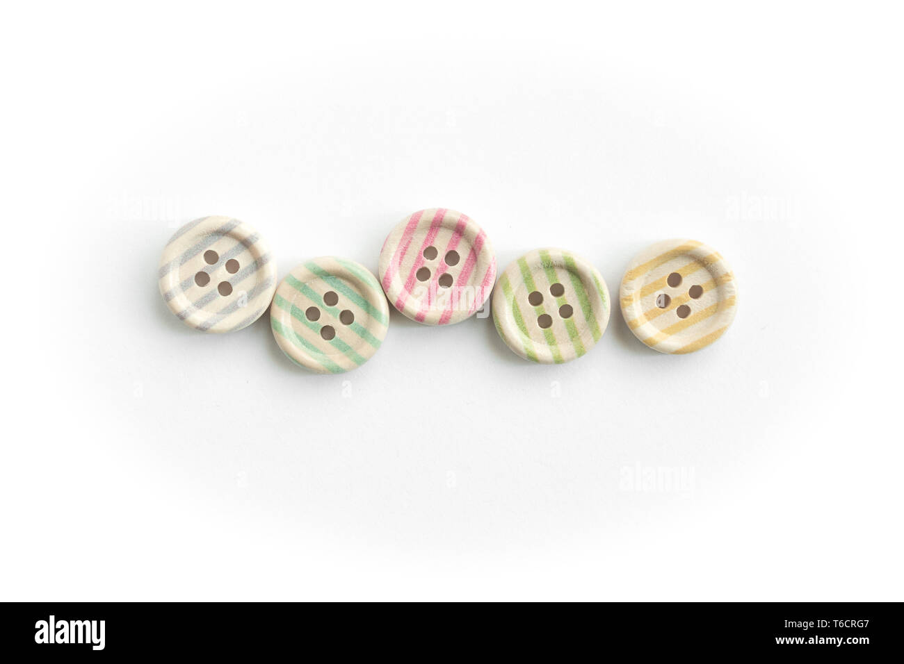 Wooden buttons with colorful stripes and colorful dots on a white ...