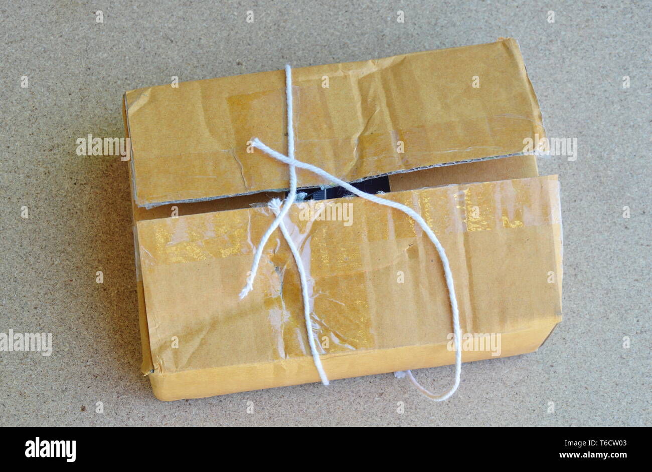 parcel rope cut and open brown postal box Stock Photo - Alamy