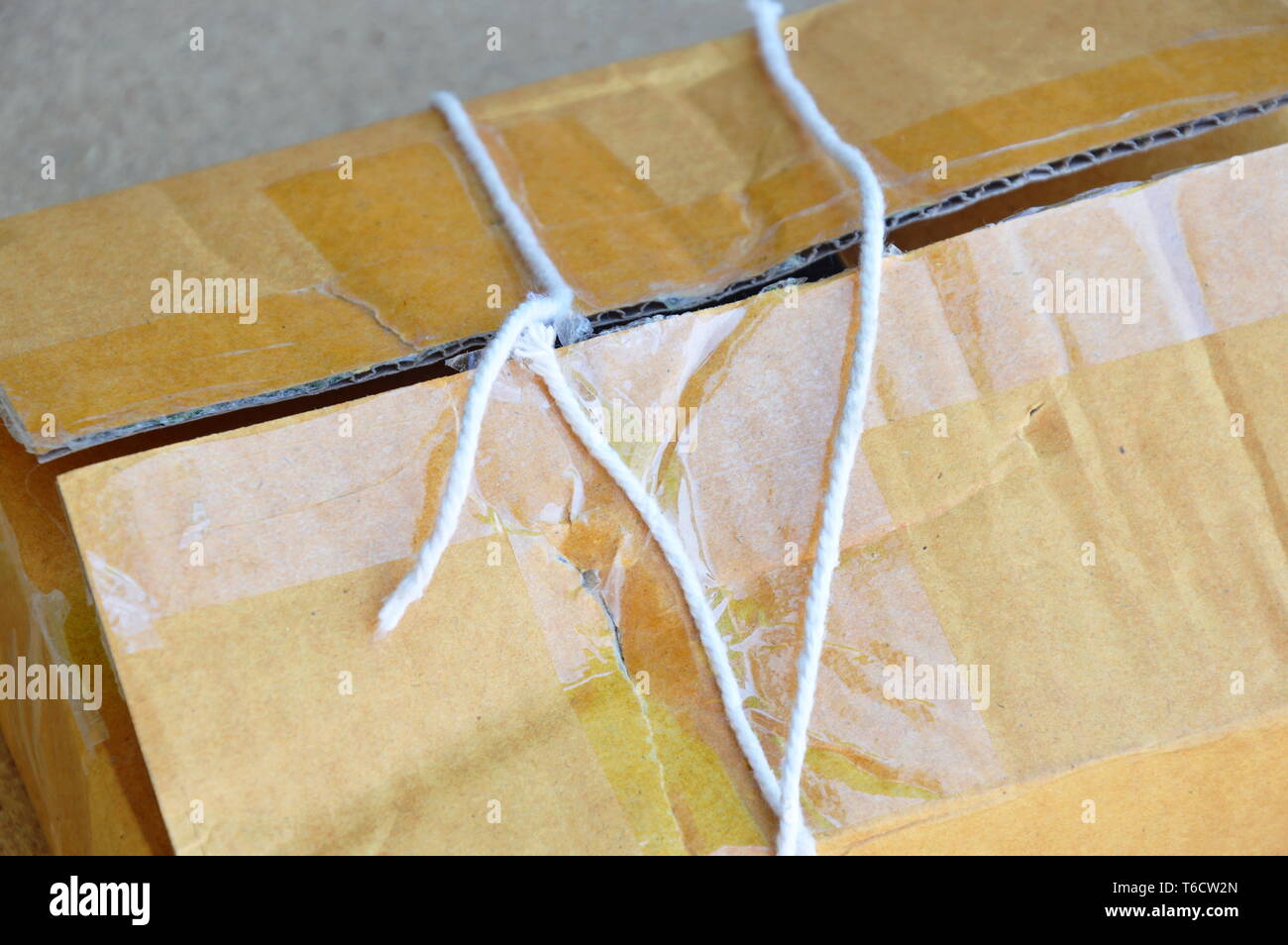 parcel rope cut and open brown postal box Stock Photo - Alamy