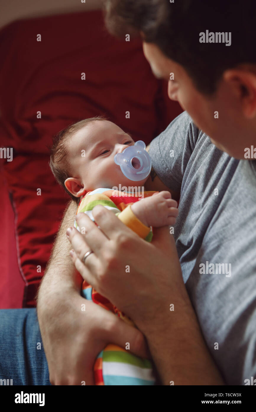 Young Caucasian father with baby. Male man parent rocking child on his ...