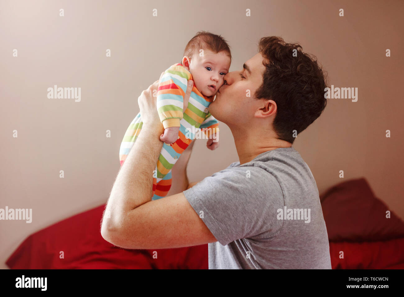 Young Caucasian father hugging and kissing newborn baby. Male man ...