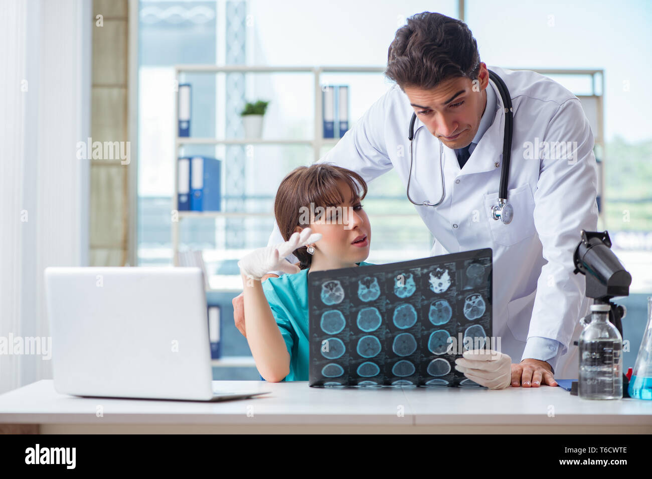 Two doctors discussing x-ray MRI image in hospital Stock Photo - Alamy