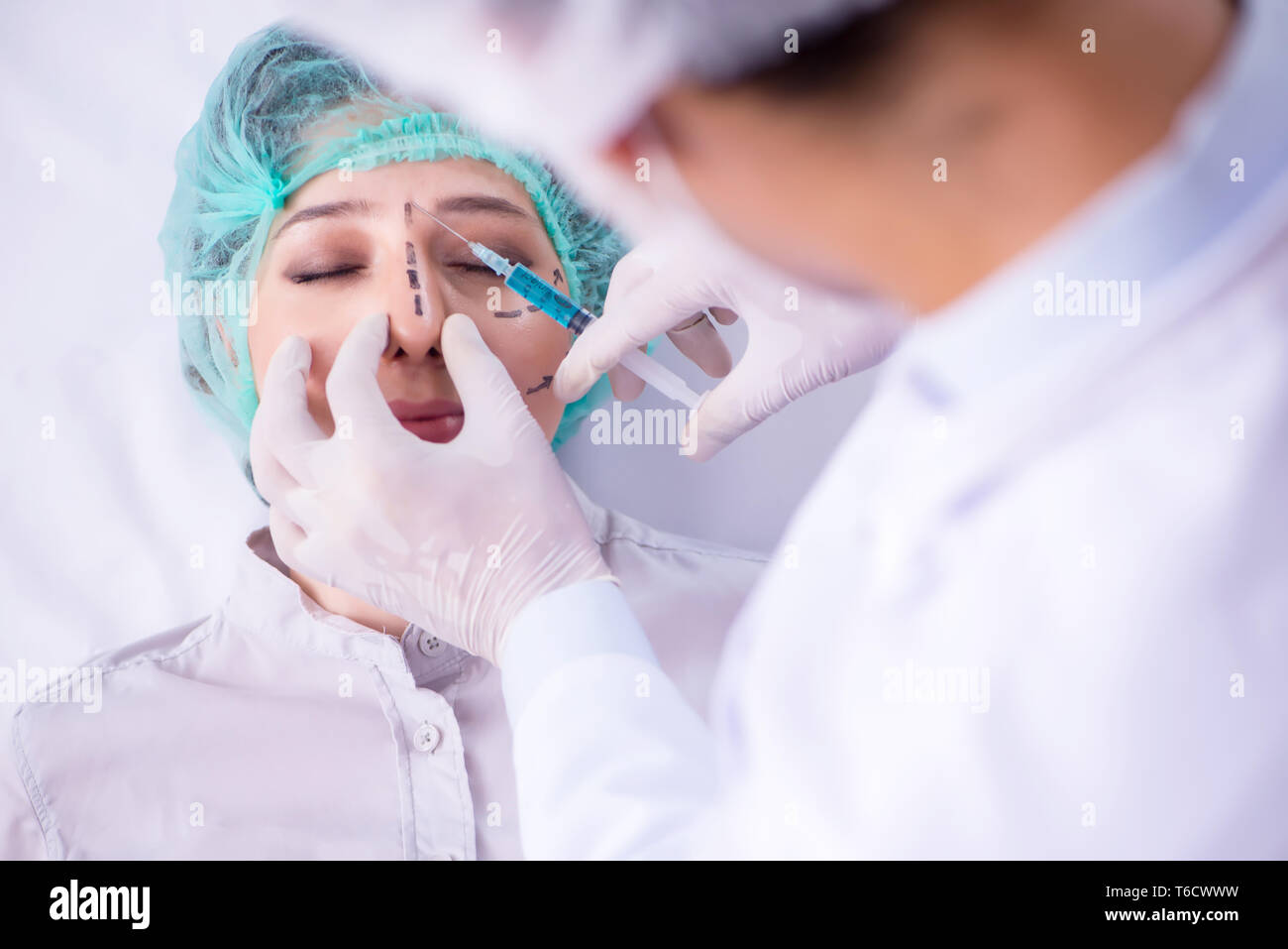 Plastic surgeon preparing for operation on woman face Stock Photo - Alamy
