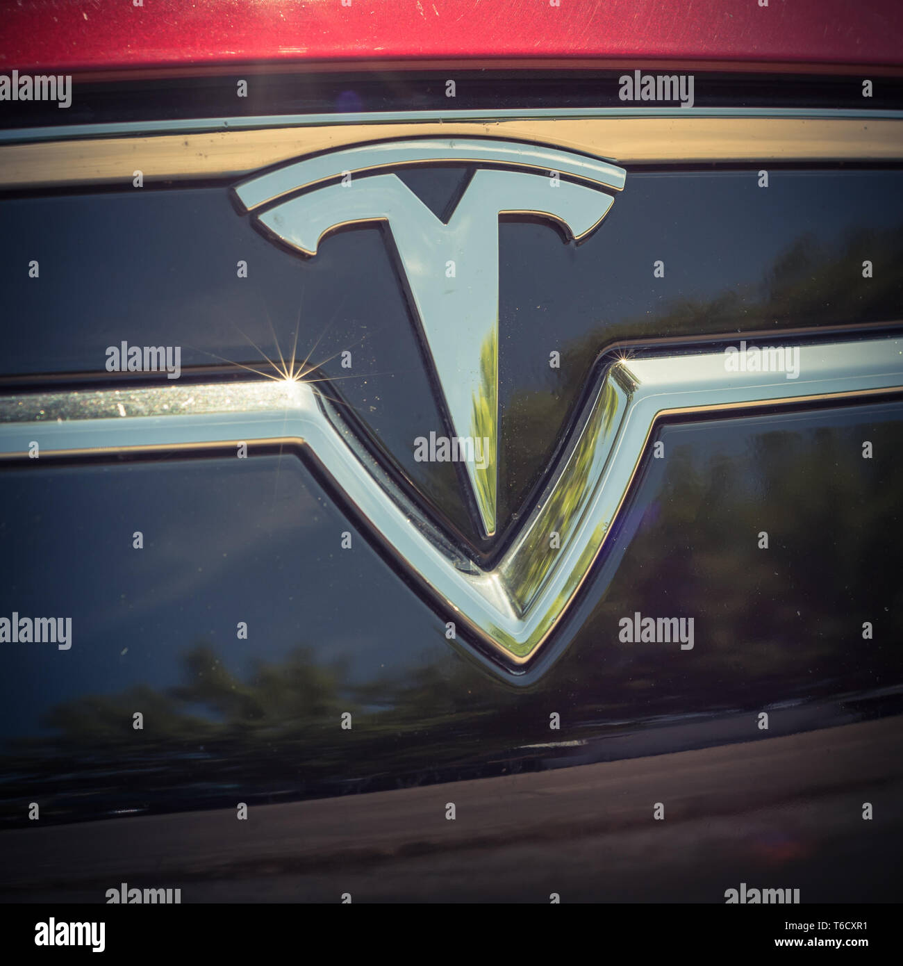 Red car hood cover with Tesla logo close-up Stock Photo - Alamy