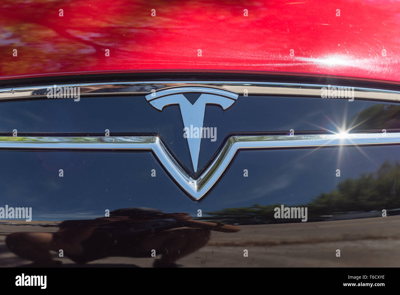 Red car hood cover with Tesla logo close-up Stock Photo - Alamy