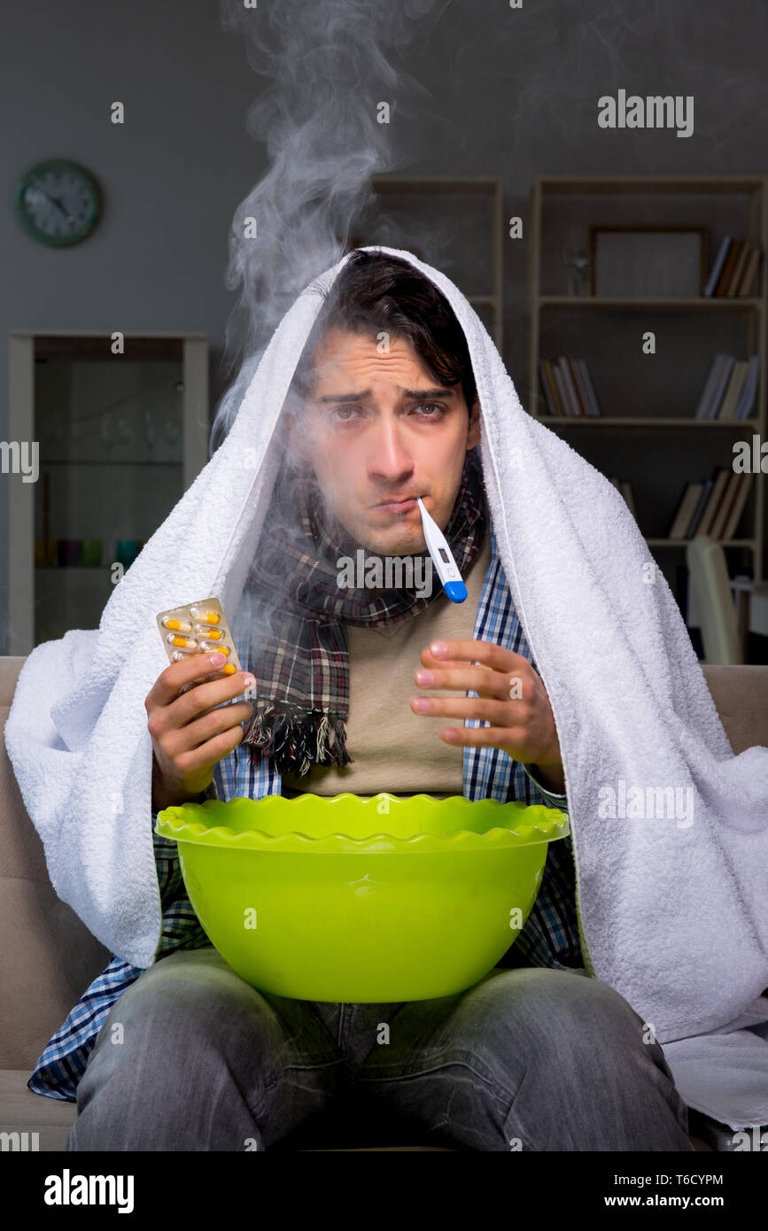 Sick man doing inhalation at night in home Stock Photo - Alamy
