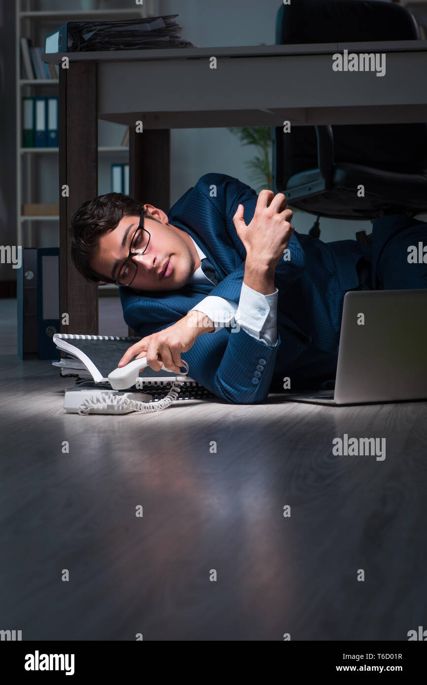 Businessman working overtime long hours late in office Stock Photo - Alamy