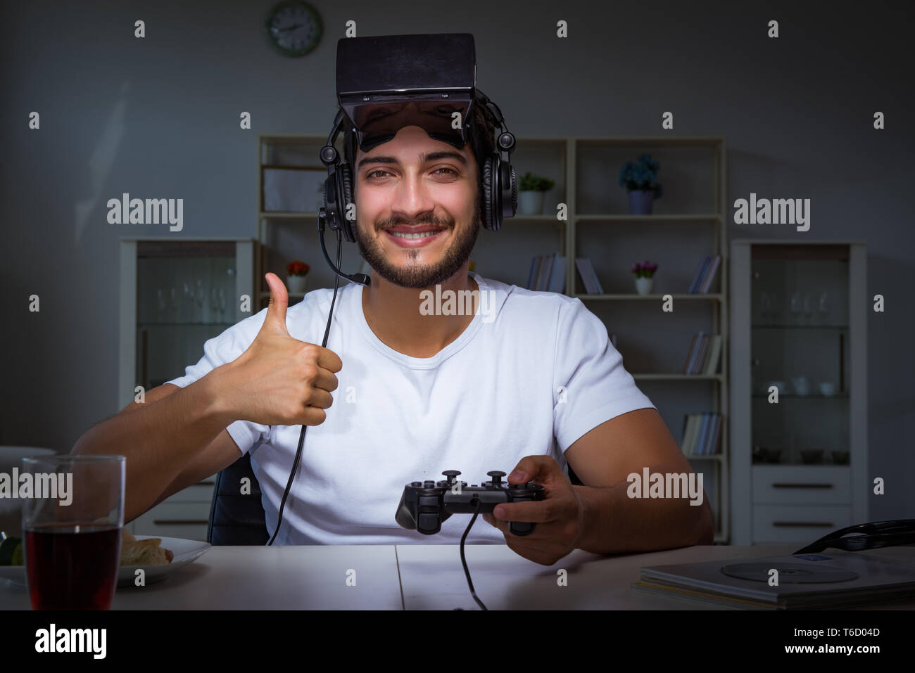 Young man playing games long hours late in the office Stock Photo - Alamy