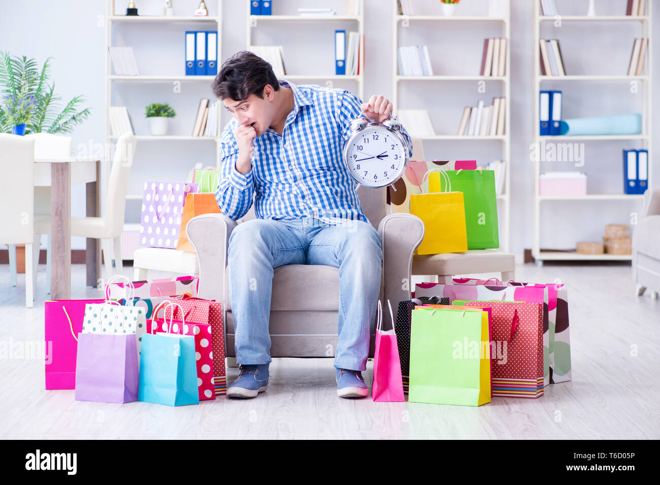 Young man after excessive shopping at home Stock Photo - Alamy