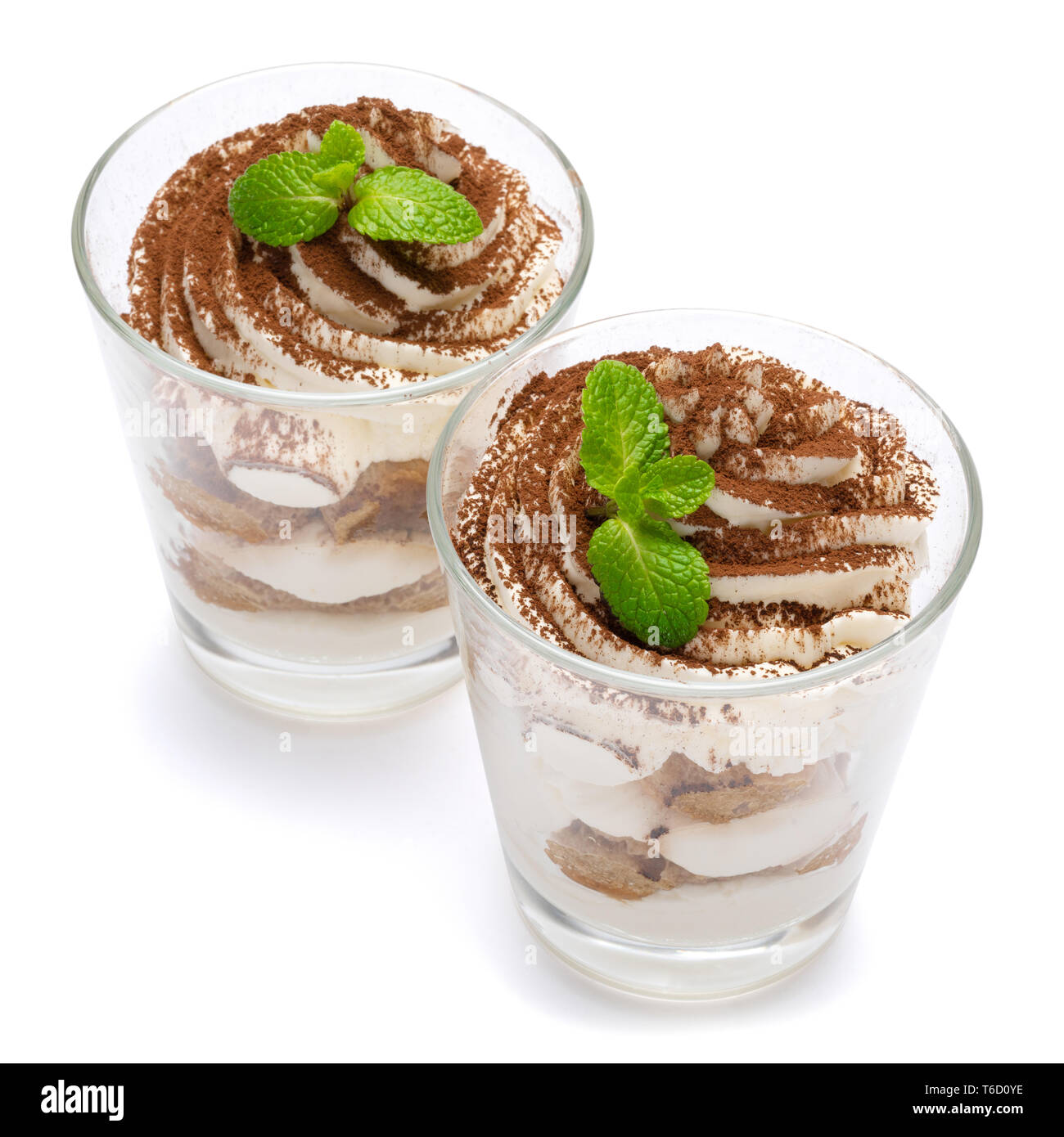 two portions Classic tiramisu dessert in a glass isolated on a white ...