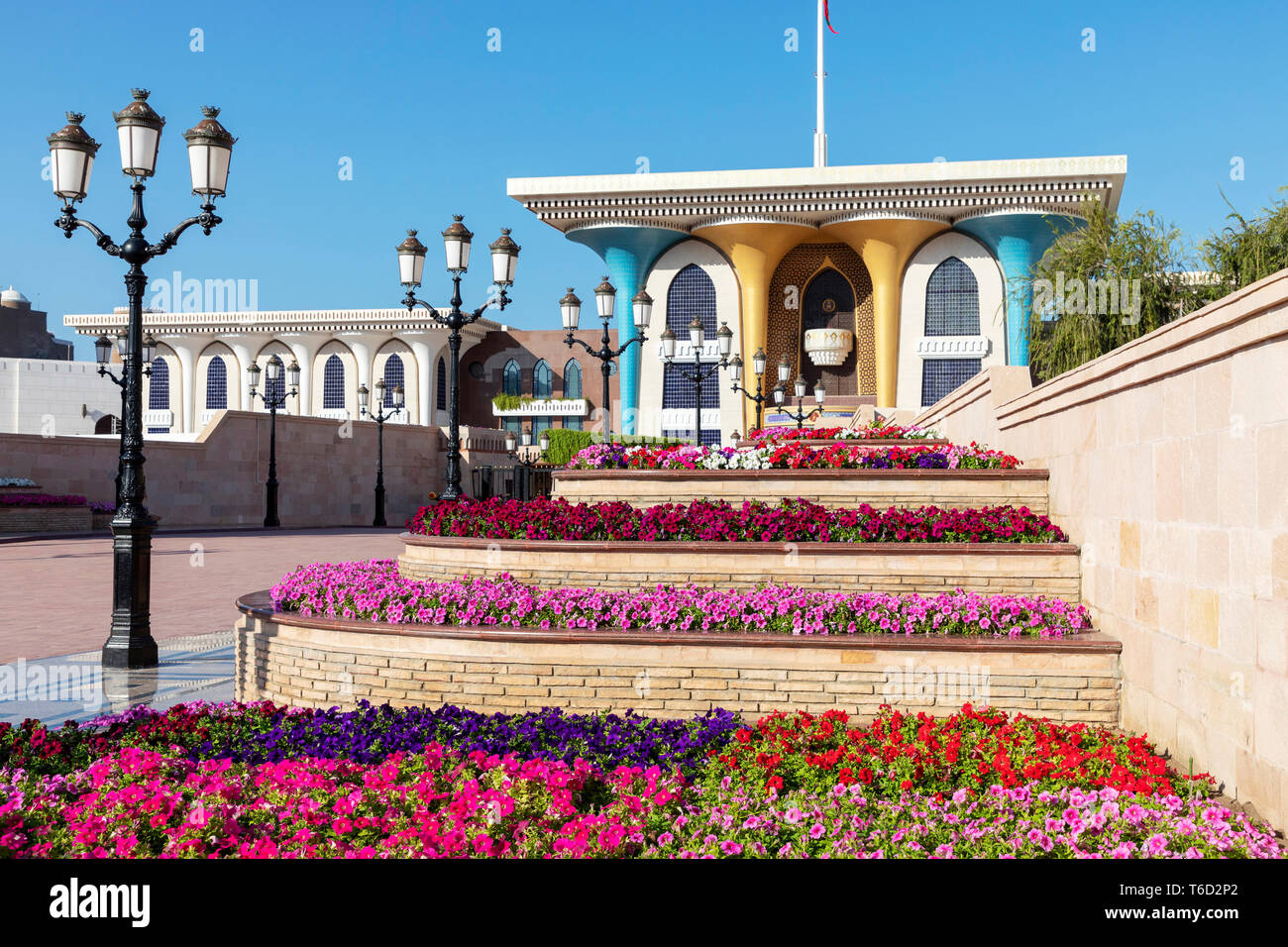Middle East, Oman, Muscat. Rows of colourful flowers planted in front ...
