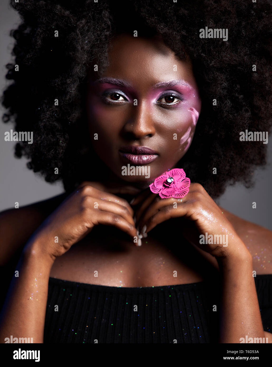 Afro and Flower beauty with big black hair smooth dark skin Stock Photo ...
