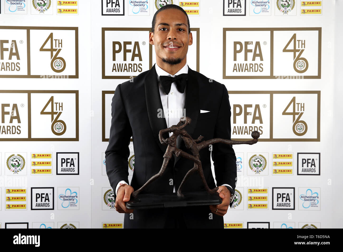 Liverpool's Virgil van Dijk poses with his PFA Team of the Year award ...