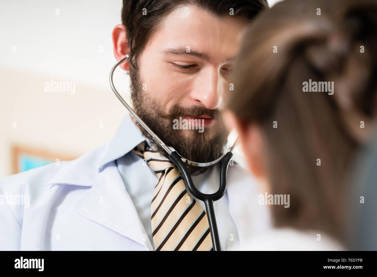 Doctor checking patient Stock Photo - Alamy