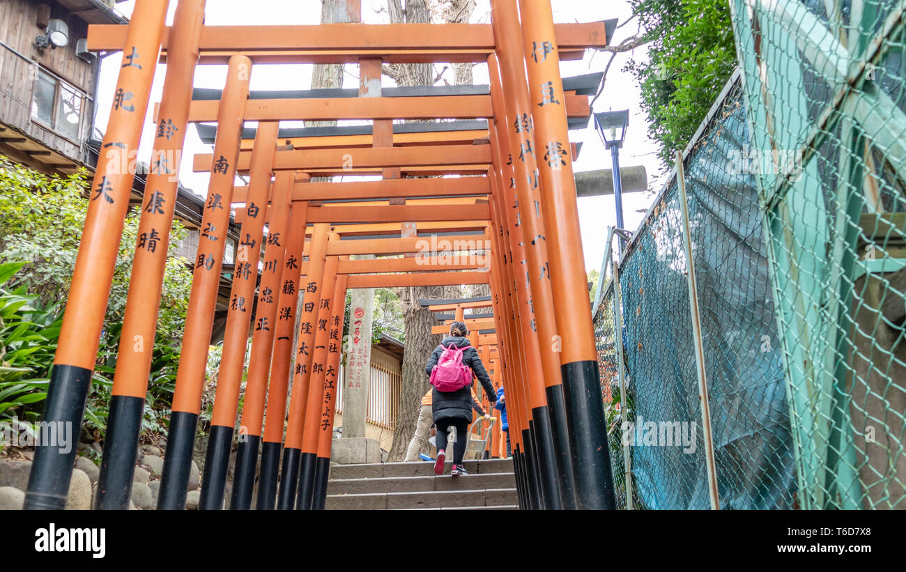 TOKYO, JAPAN - FEBRUARY 8, 2019: Torii tunnel leading to Hanazono Inari ...